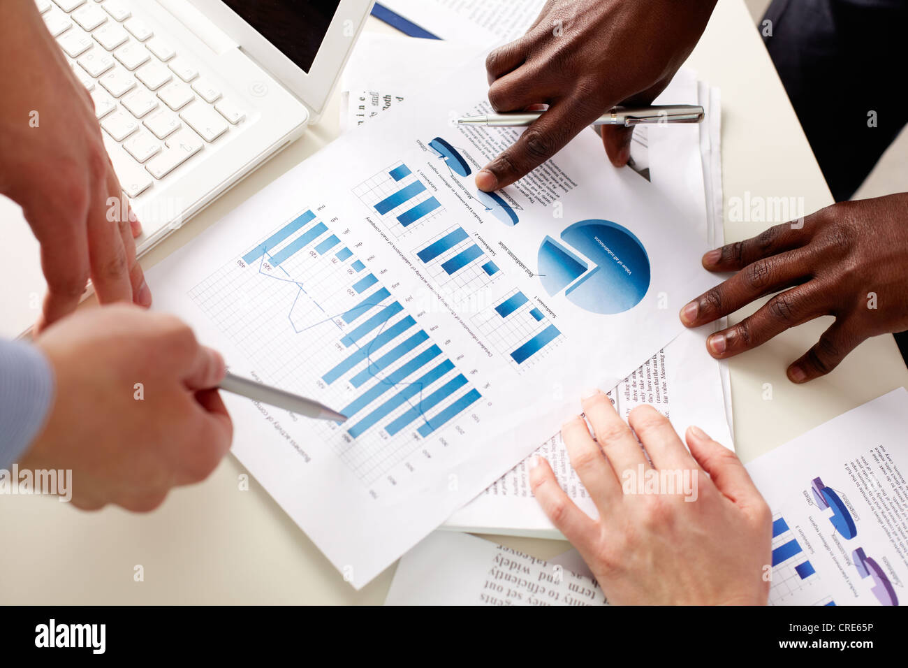 Business people discussing the charts and graphs showing the results of ...