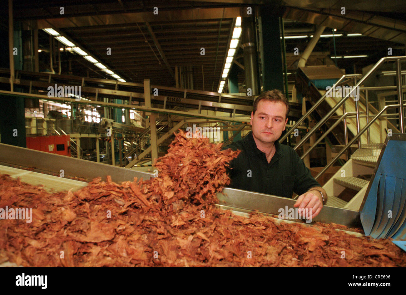 A worker at Philip Morris factory in Berlin-Neukoelln, Germany Stock ...