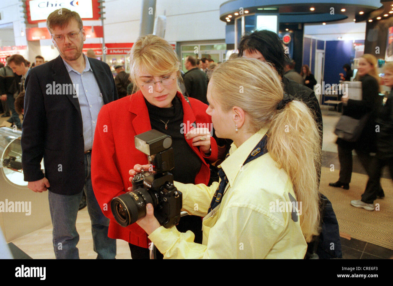 Visitors informiernen CeBIT 2001 at the booth of Japanese camera manufacturer Nikon, Hannover ...