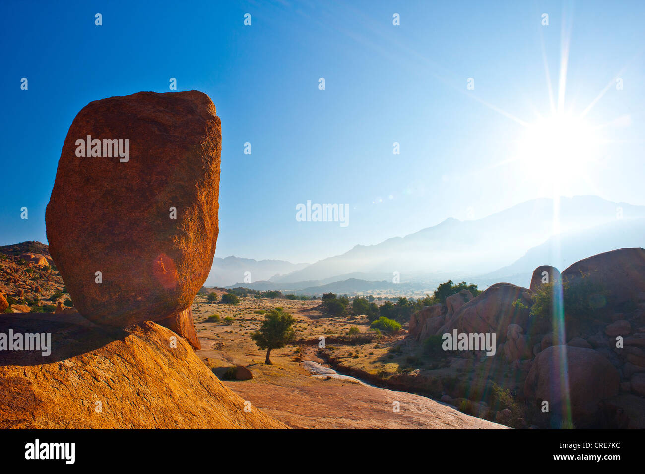 Sunrise and a huge granite boulder on a ledge in the Anti-Atlas ...