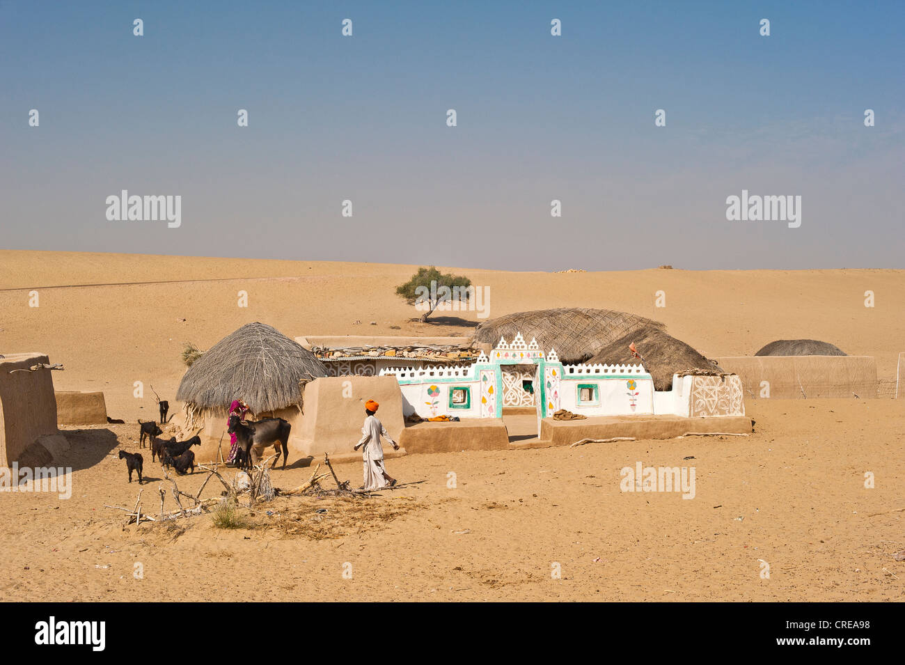 Traditional farmhouse with a painted exterior walls and twig roof in ...