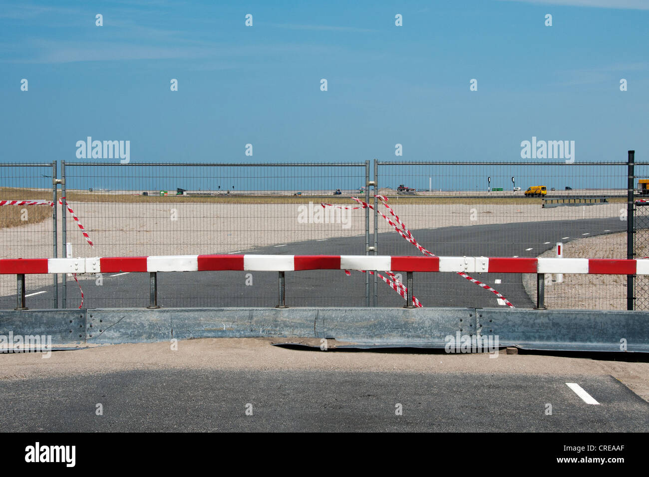 road blocked by metal fence and red white block Stock Photo - Alamy