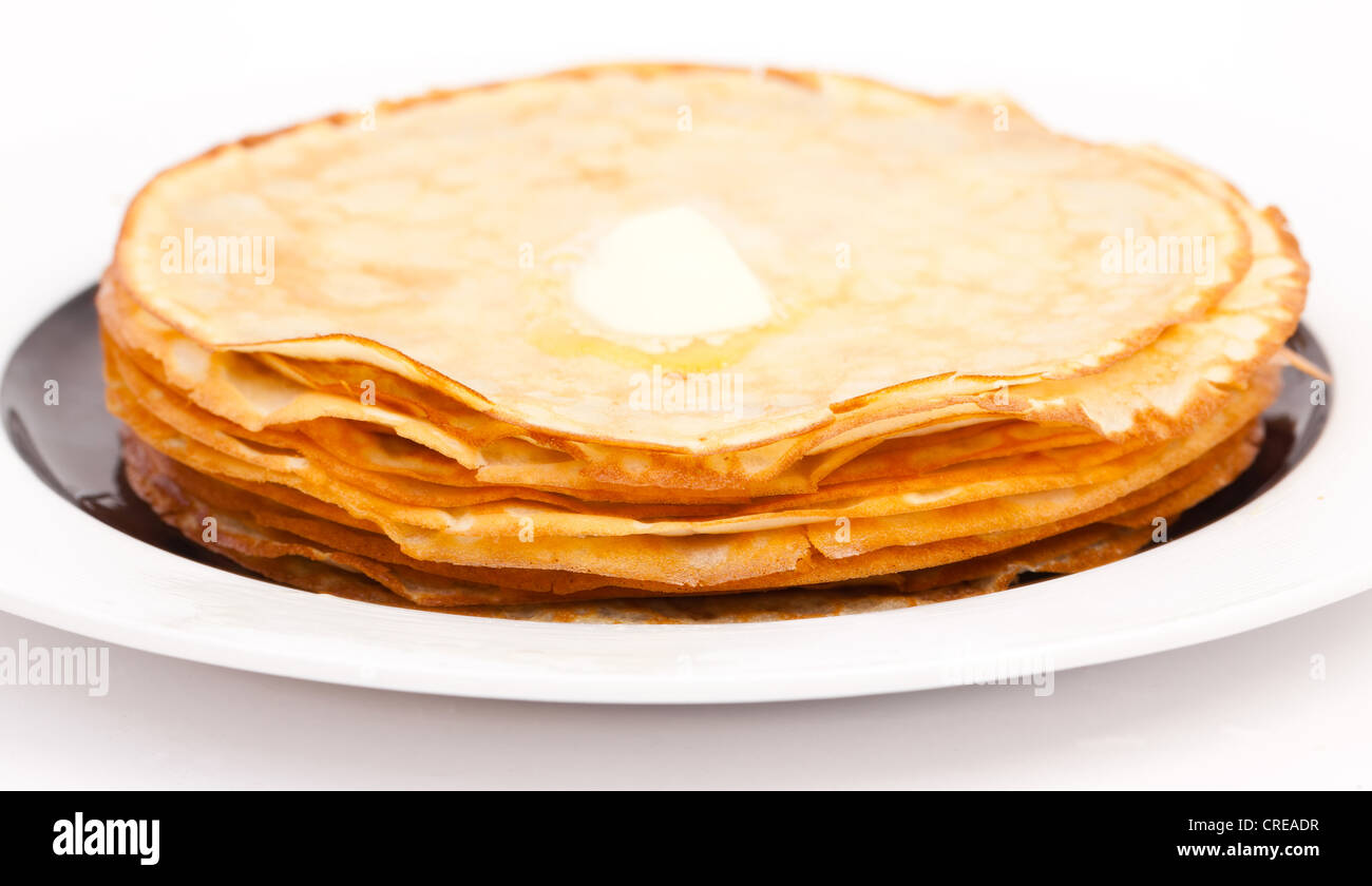 Golden pancakes on white plate with butter Stock Photo - Alamy