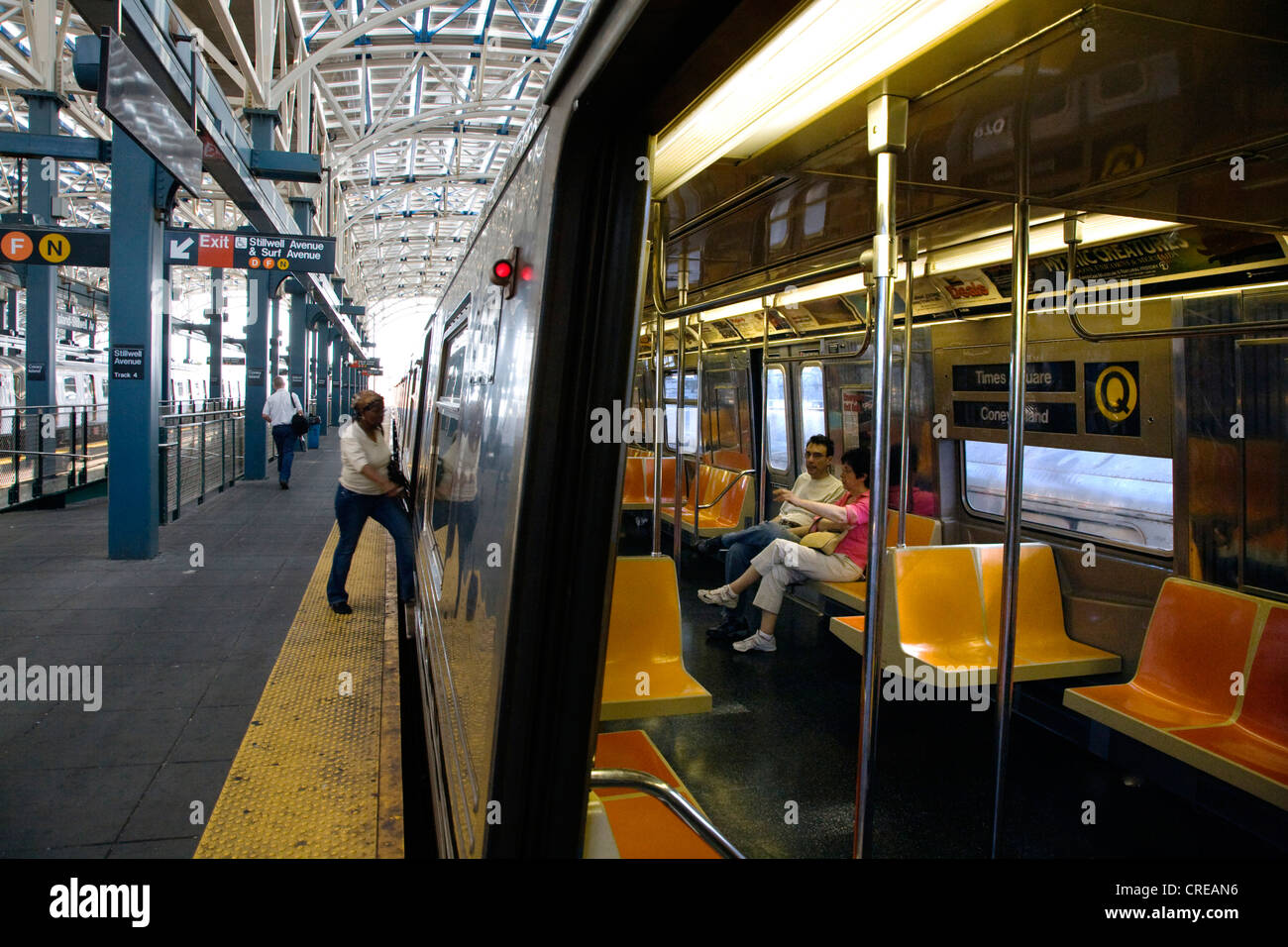 Woman stepping inside the Q TRAIN at the Stillwell Avenue Subway Stock ...