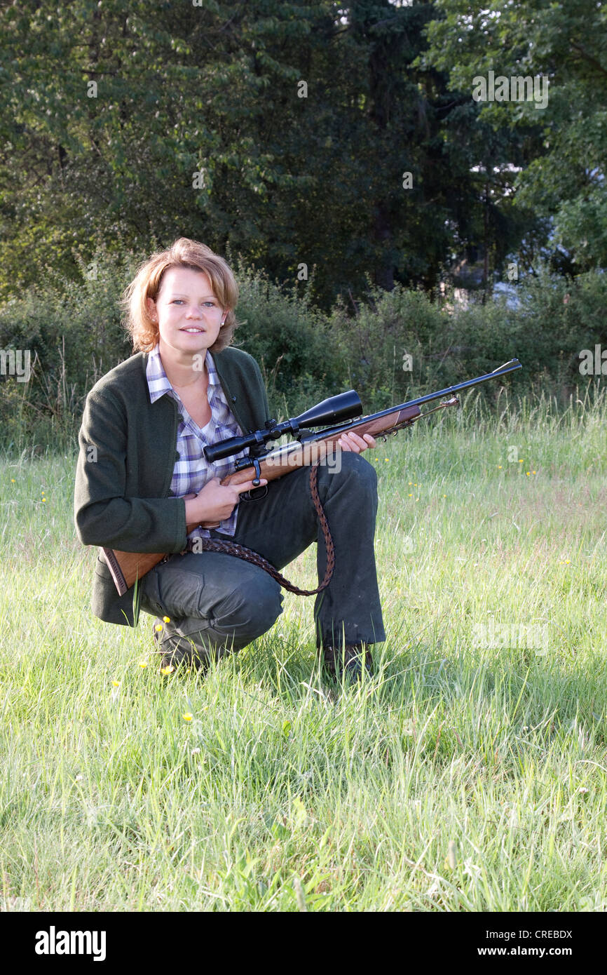 Female hunter with rifle wearing hunting clothes, Rhineland-Palatinate ...