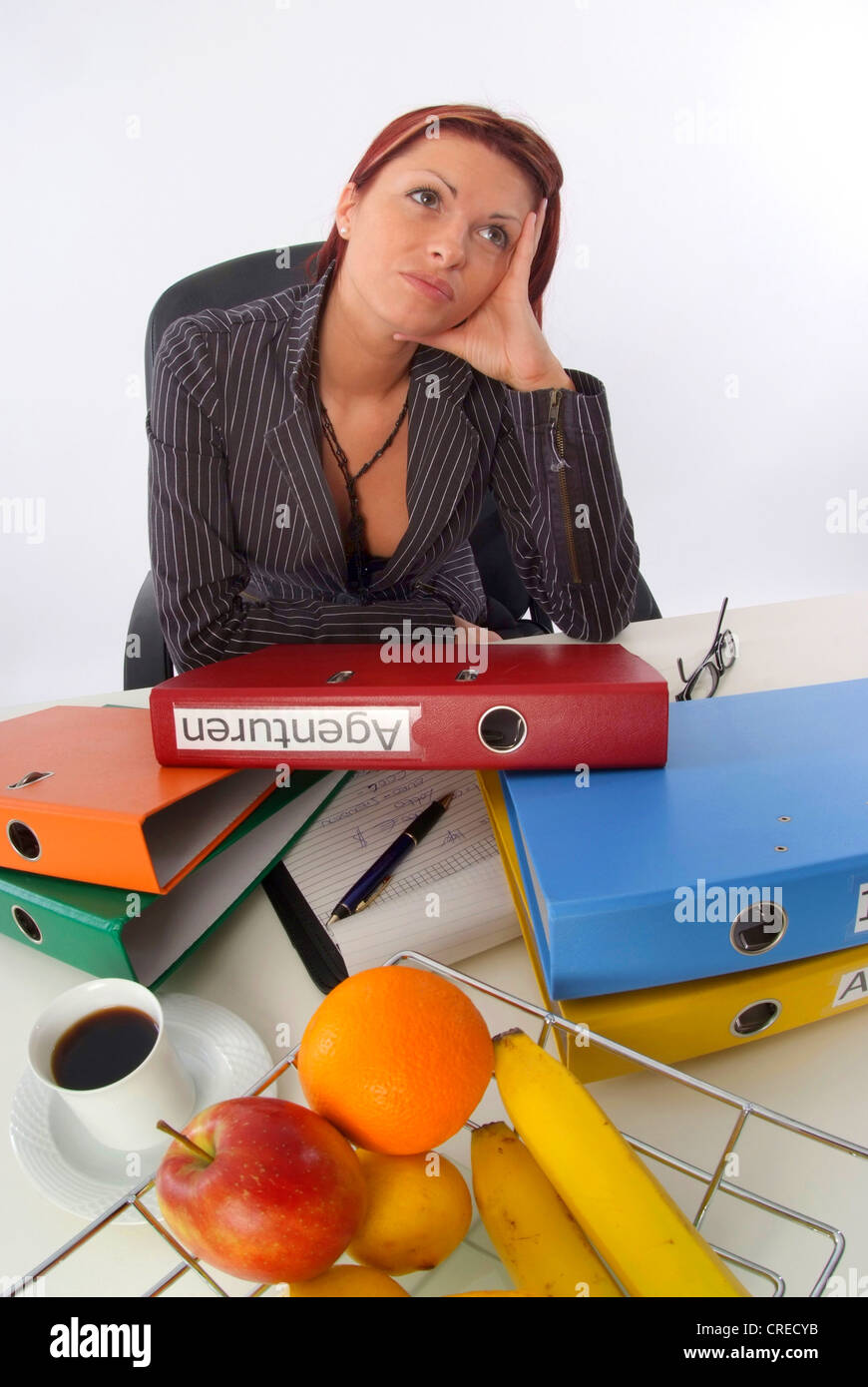 overcharged businesswoman at her desk in the office Stock Photo - Alamy