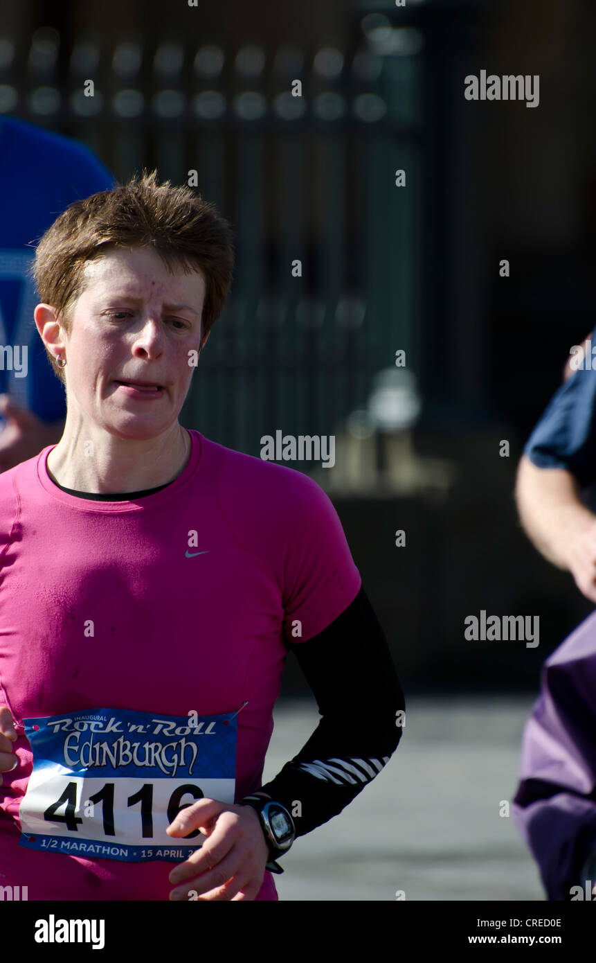 Female runner taking part in the Edinburgh Rock 'n' Roll half-marathon ...