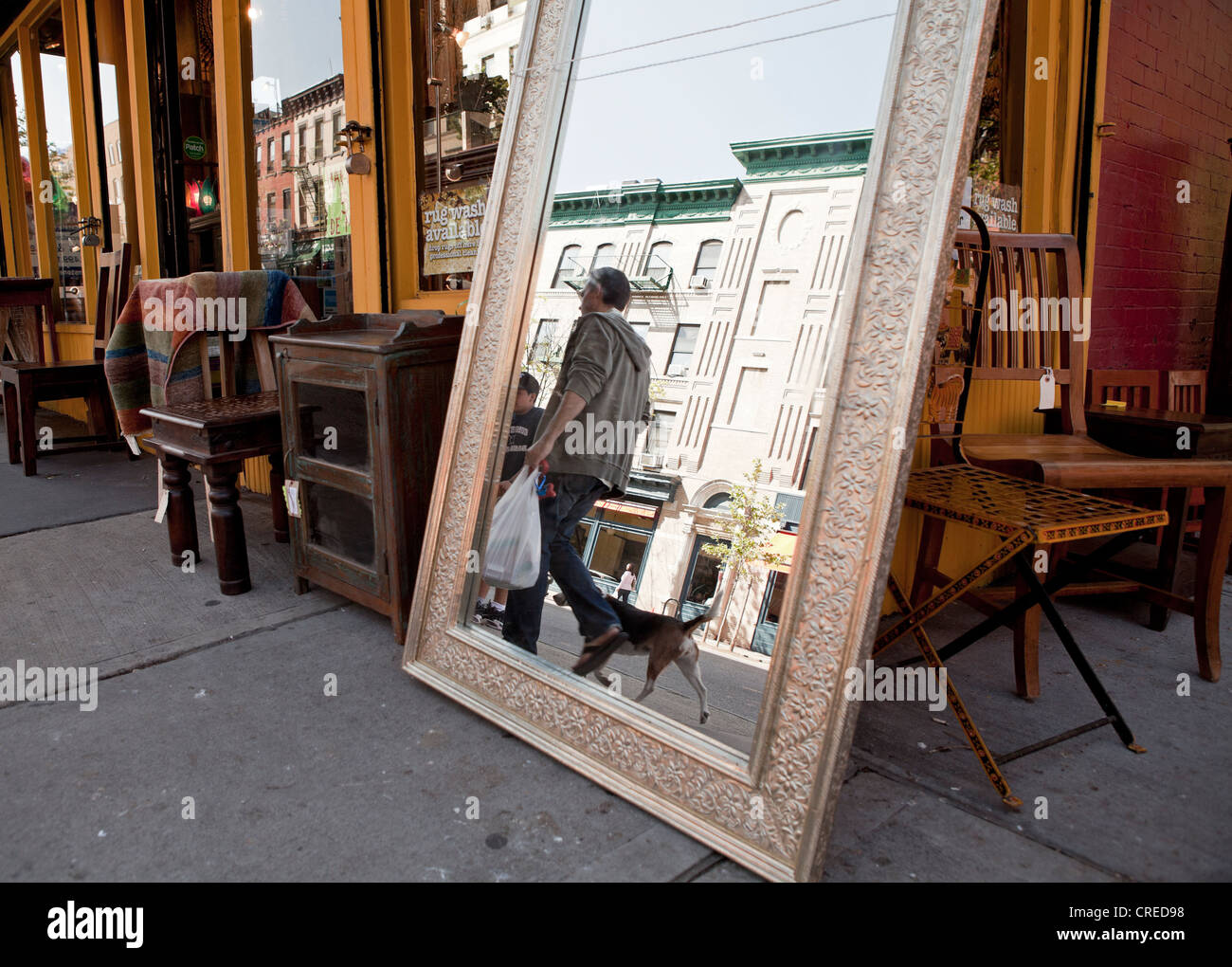 A mirror reflects passersby in the Park Slope neighborhood of Brooklyn ...