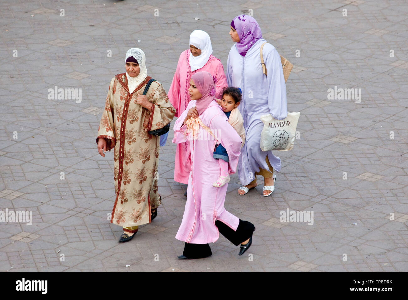 Women wearing traditional djellabas in Djemaa El Fna square, medina or ...