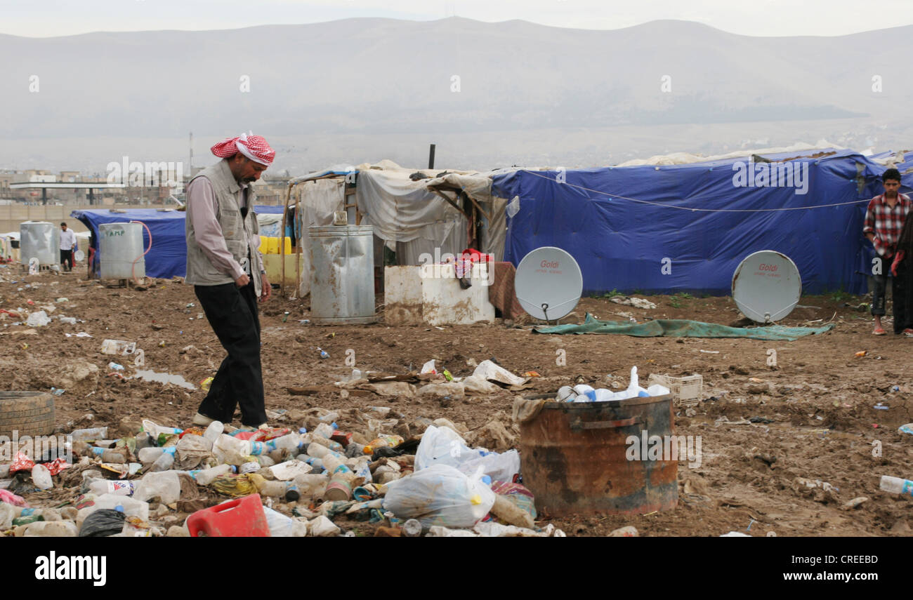 Arab refugee from Baghdad in camp in Sulaymaniyah steps through garbage ...