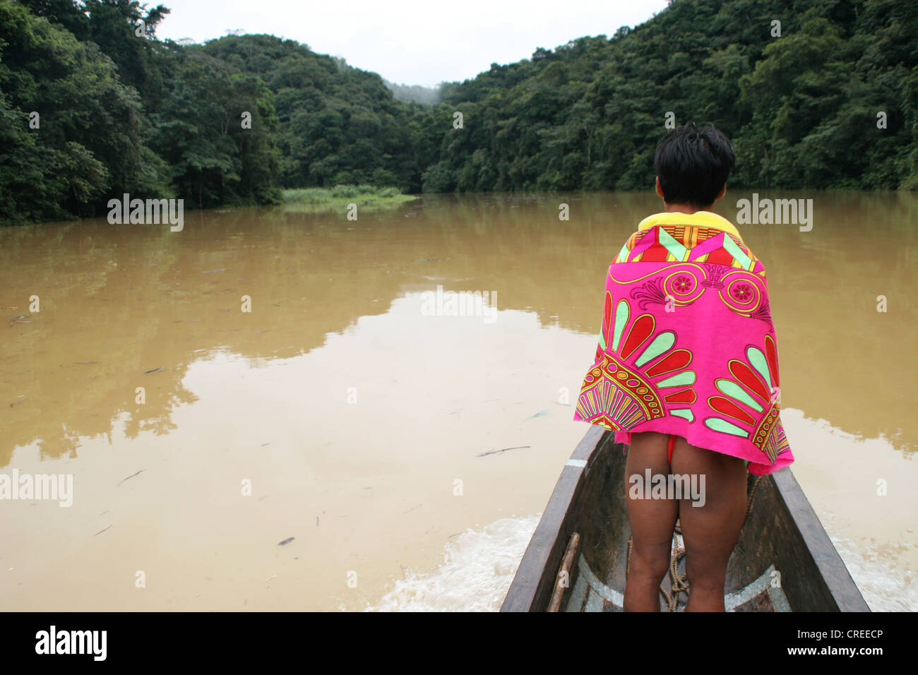 Embera Indian with traditional clothes in a dugout on Chagres River ...