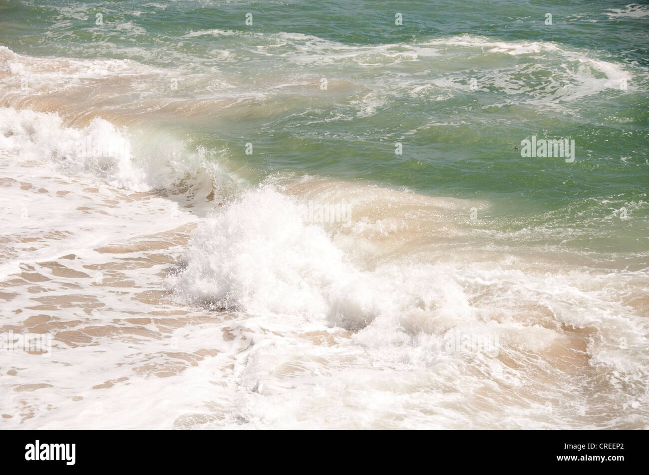 Surf crashing onto the beach Stock Photo - Alamy