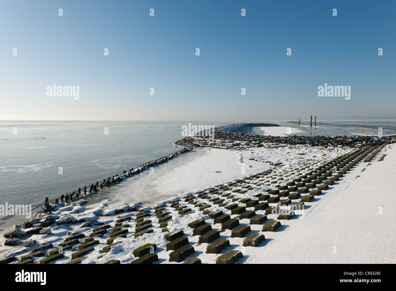 Dyke and breakwaters of Schluettsiel harbour, ferry port to the ...