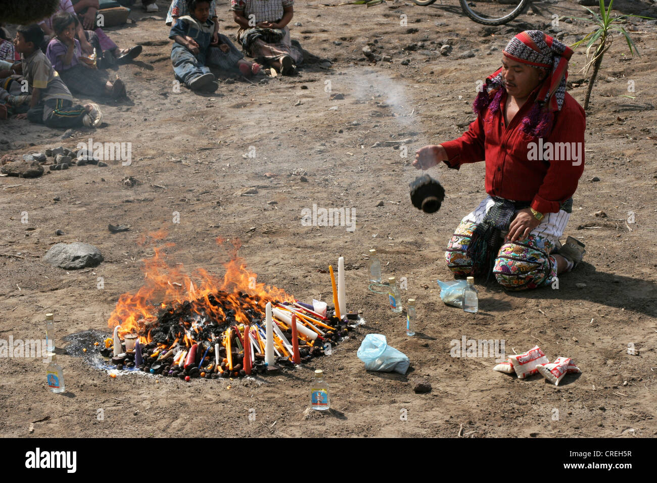 Mayan priests in ritual with Maya altar, burning candles and ...