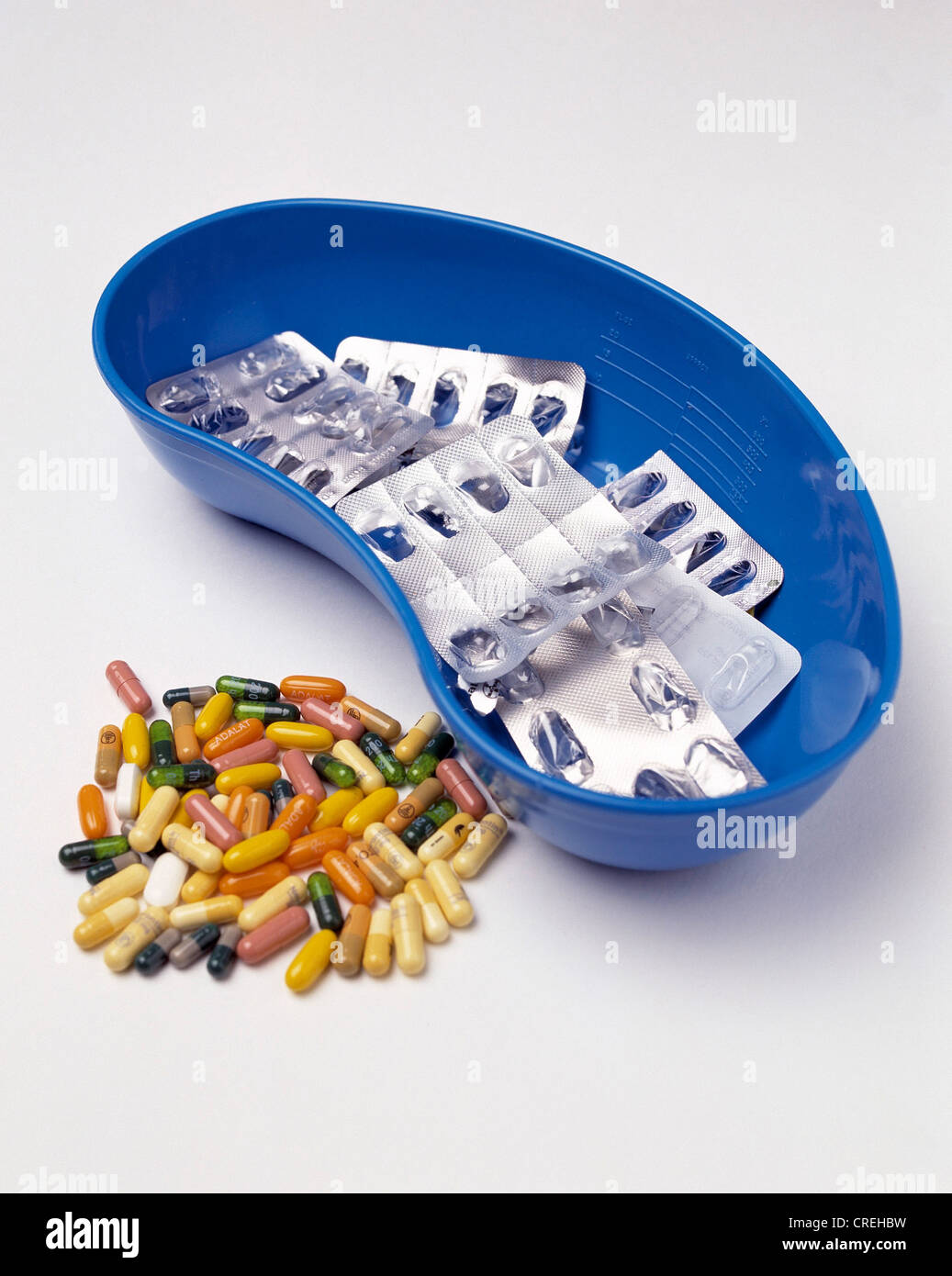 Tablets are next to a blue kidney dish with empty blisters Stock Photo ...
