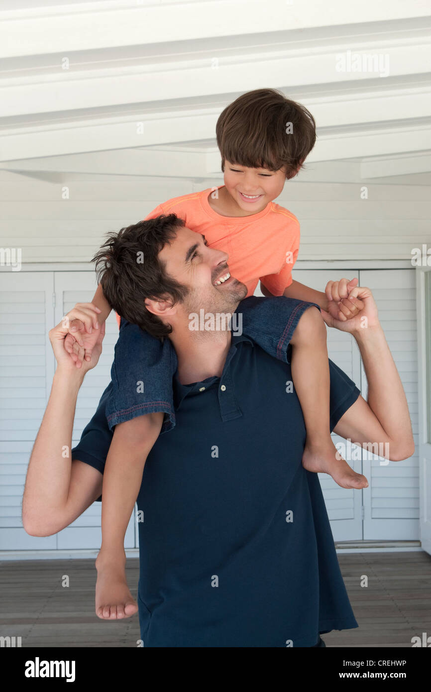 Father carrying son on shoulders Stock Photo - Alamy