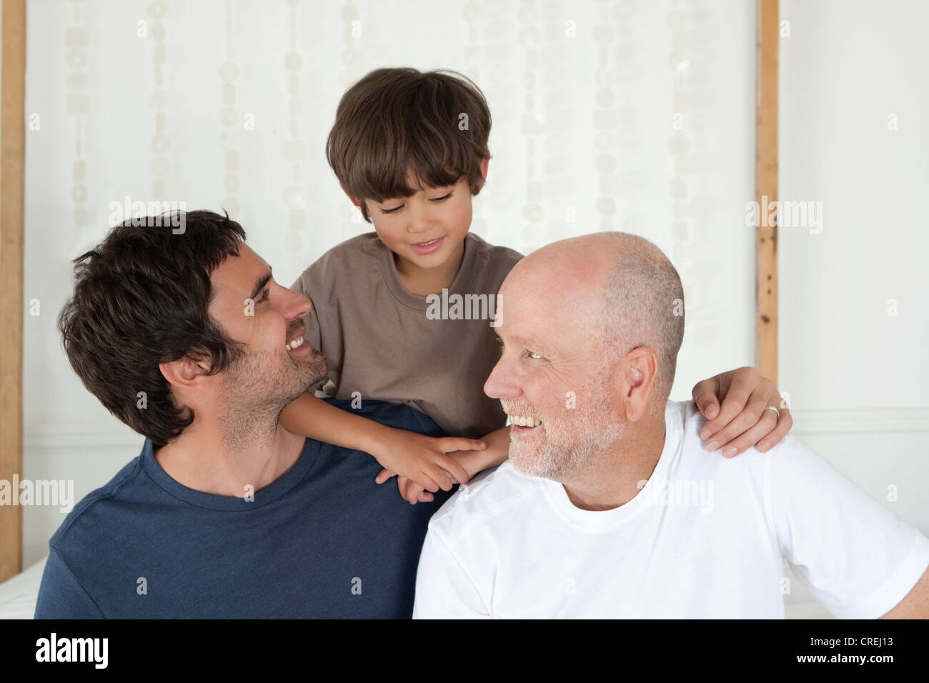 Three generations of men on bed Stock Photo - Alamy