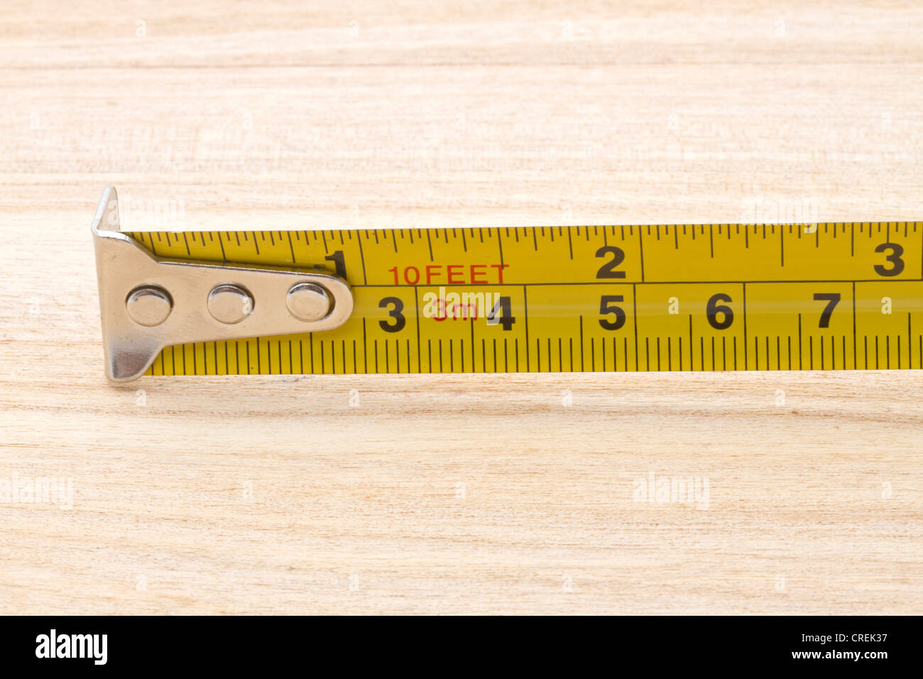 Tape measure closeup on wood background Stock Photo - Alamy