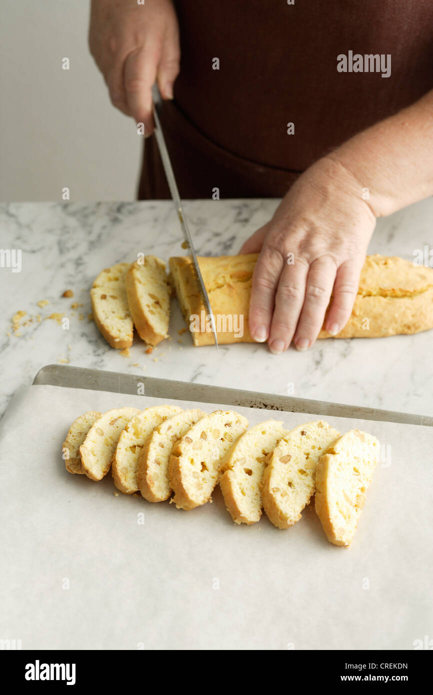 Chef slicing bread in kitchen Stock Photo - Alamy