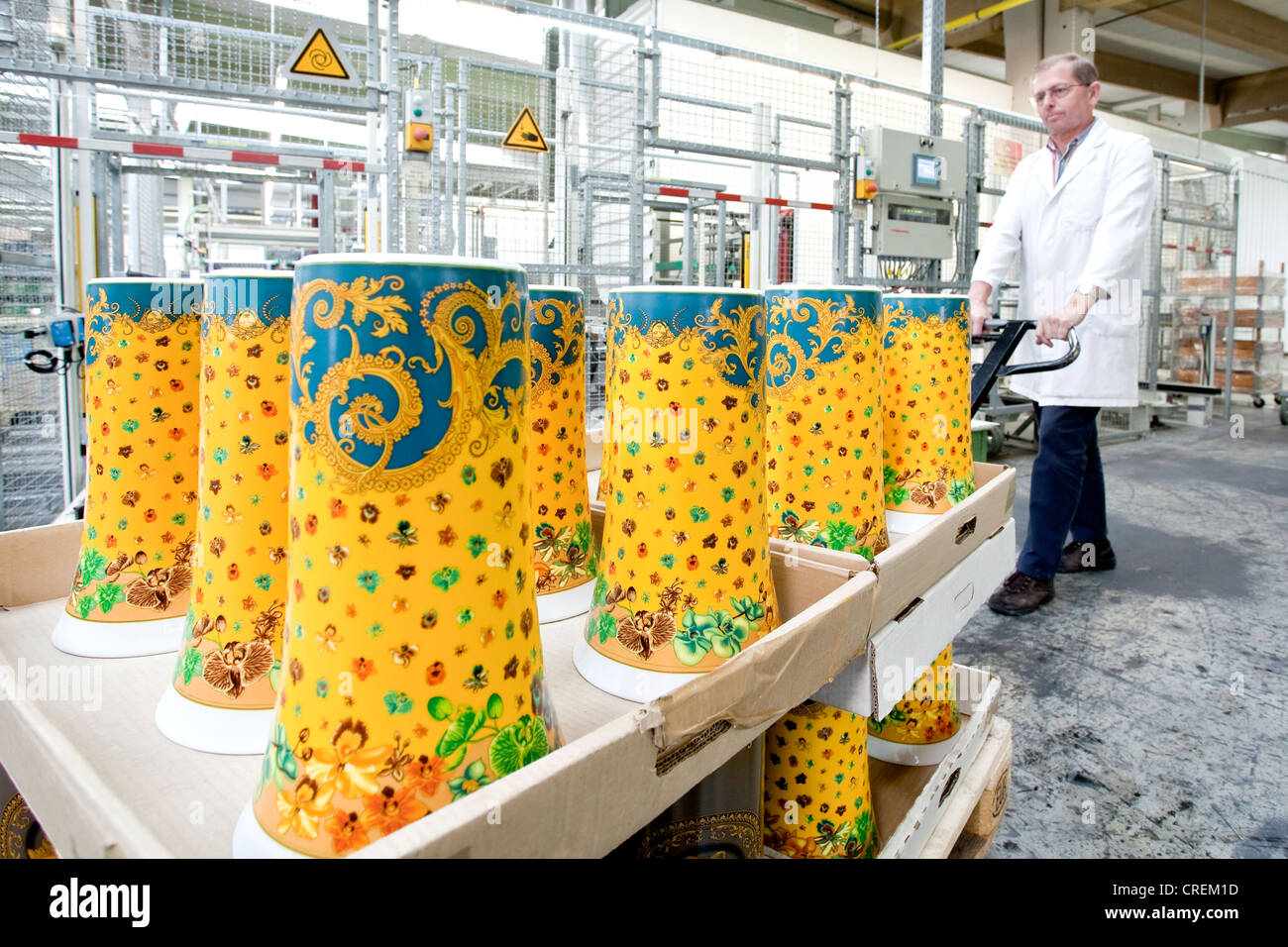 Employee transporting unfired Versace vases to the kiln of the ...