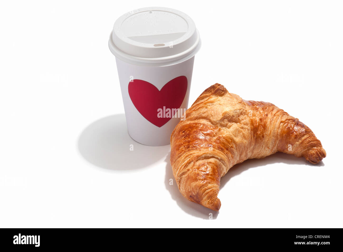 A croissant and a takeaway drink cup Stock Photo - Alamy