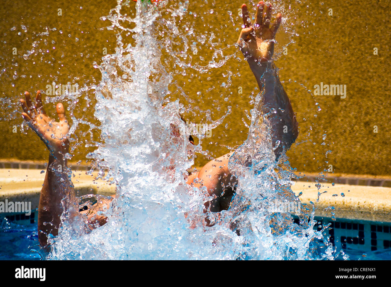 person playing in a swimming pool masked by splash of water Stock Photo ...