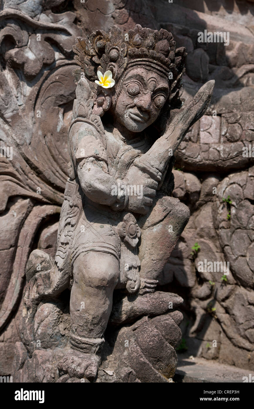 Temple figure holding a Kris sword and adorned with a blossom, Bura ...