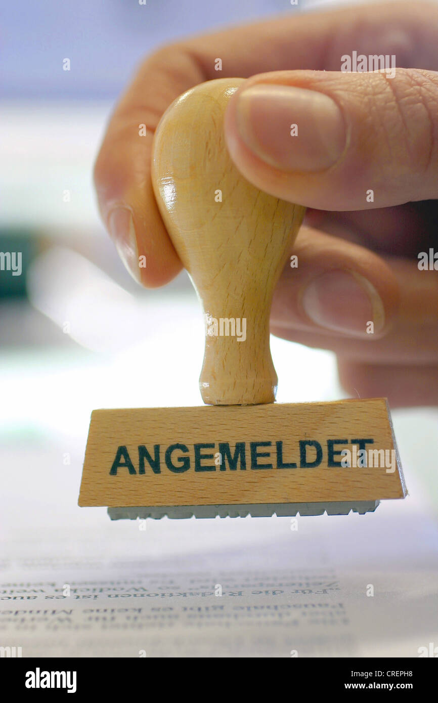 hand with a stamp Angemeldet, declared Stock Photo - Alamy