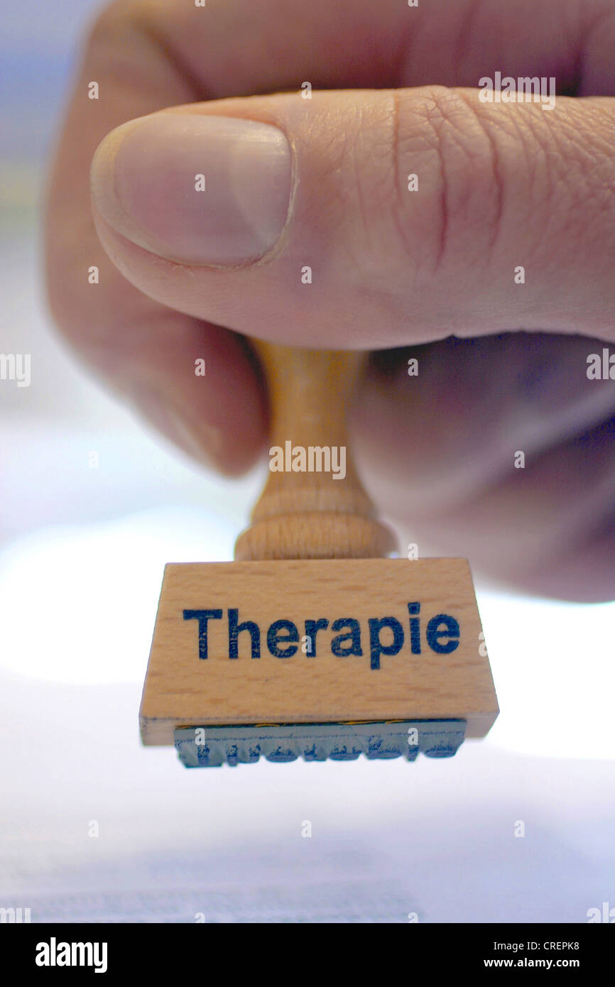 hand with a stamp Therapie, therapy Stock Photo - Alamy