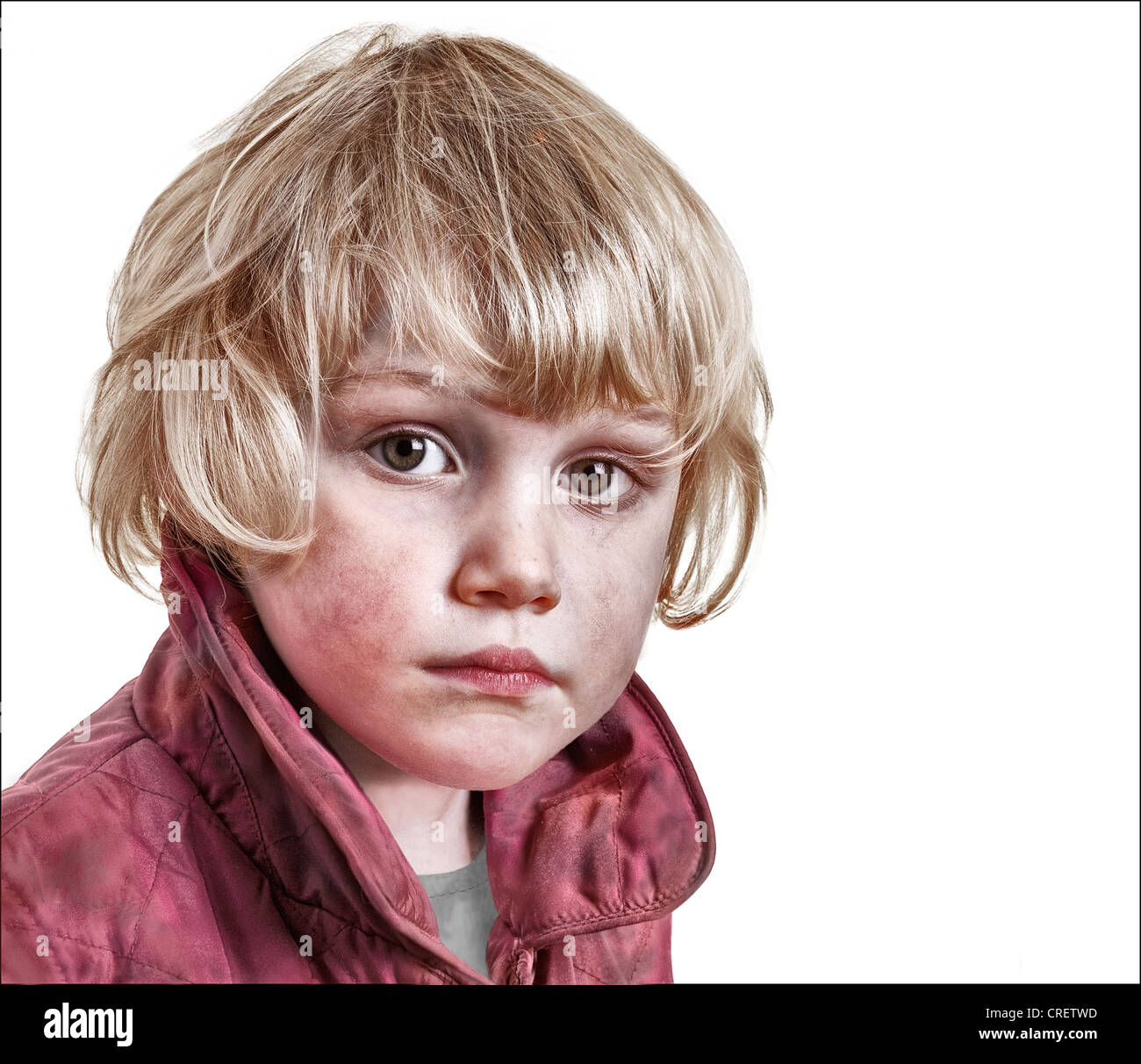 Portrait of a dejected blonde scruffy 4 year old kid dressed in grubby ...