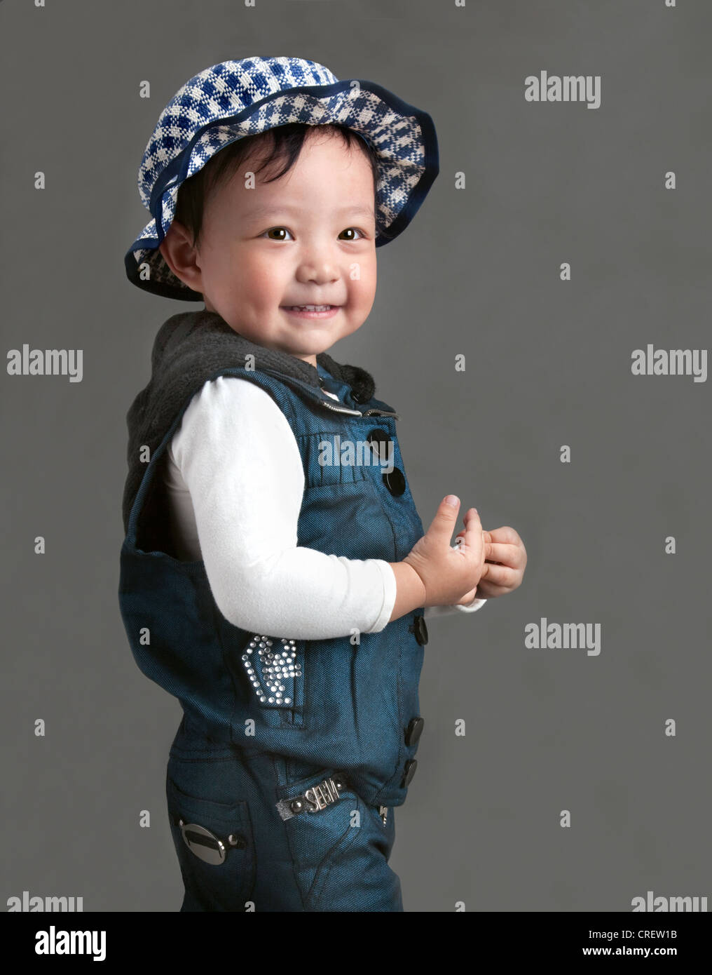 Very capable 2 year old Chinese girl standing side view wearing trendy ...