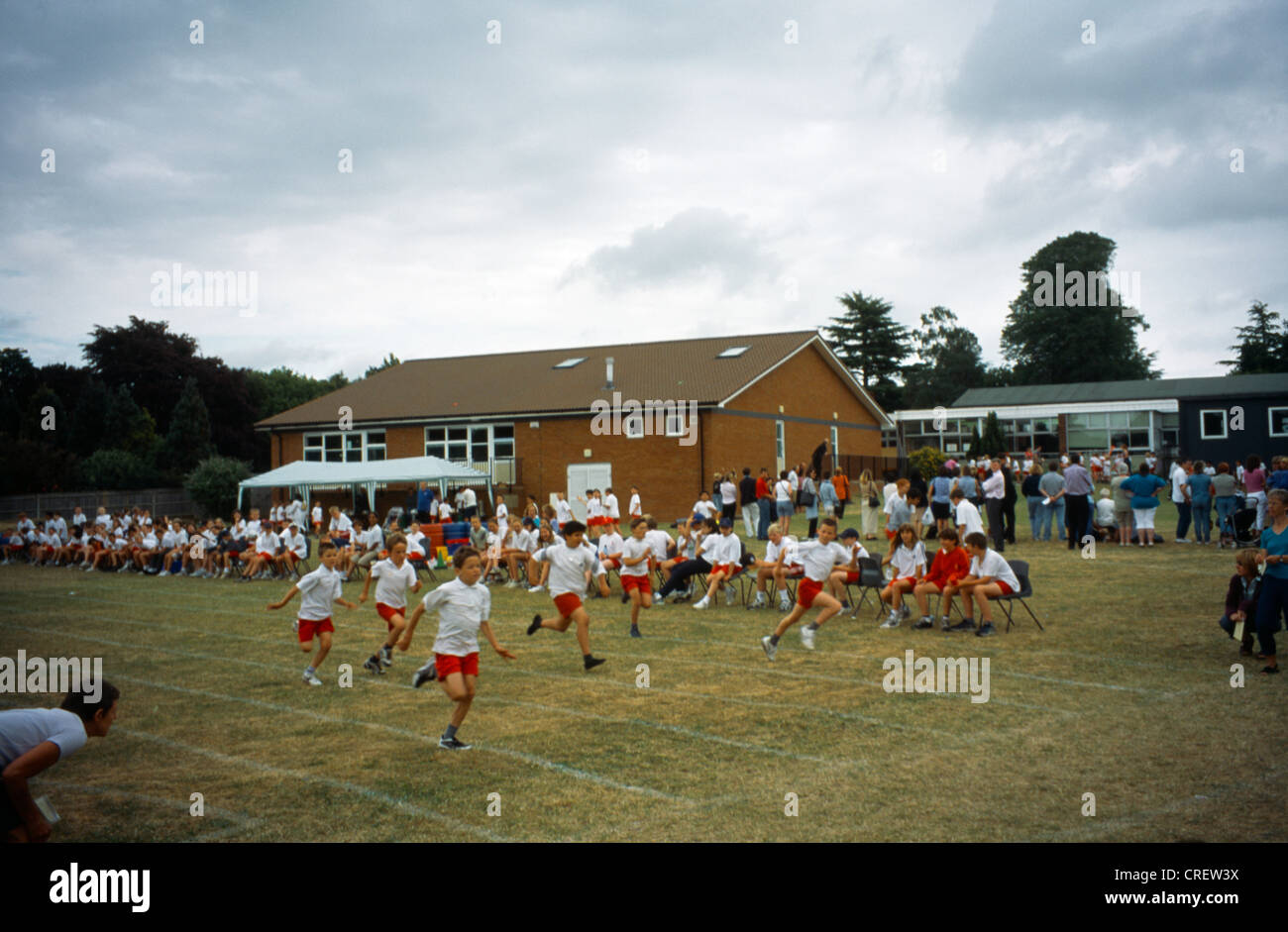 Children Approaching Finishing Line At Race On Sports Day At Primary ...