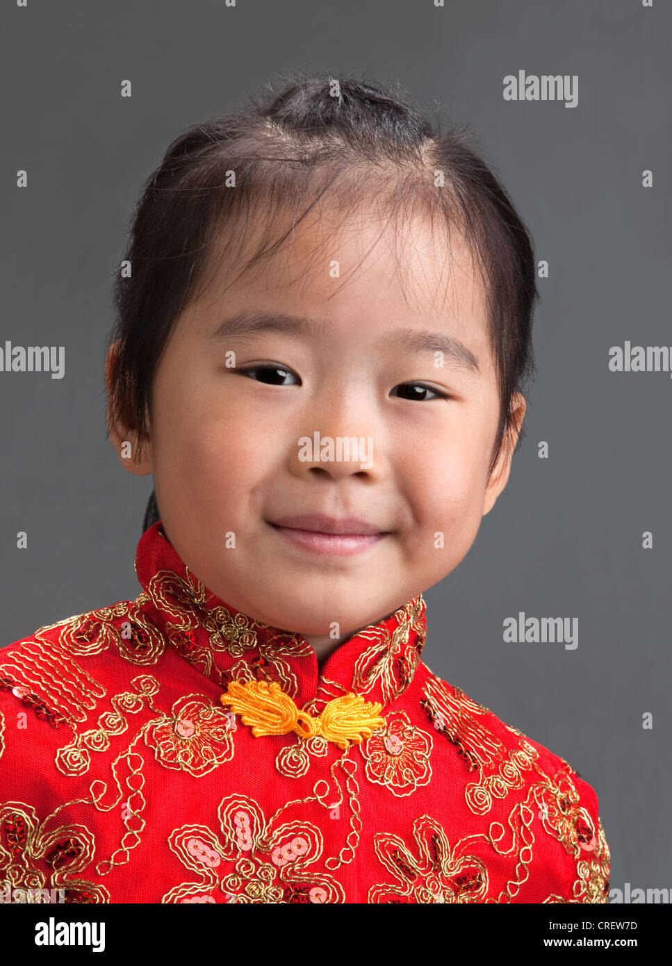 Head and shoulders portrait of a smiling 5 year old Chinese girl ...