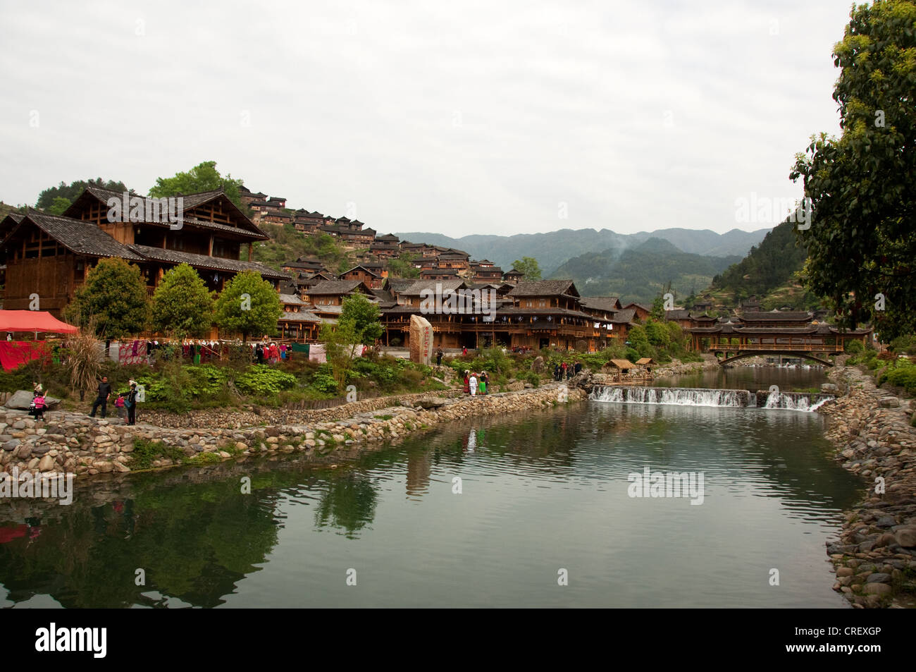 A traditional Miao bridge over Xi River in Xijiang Miao village, China ...