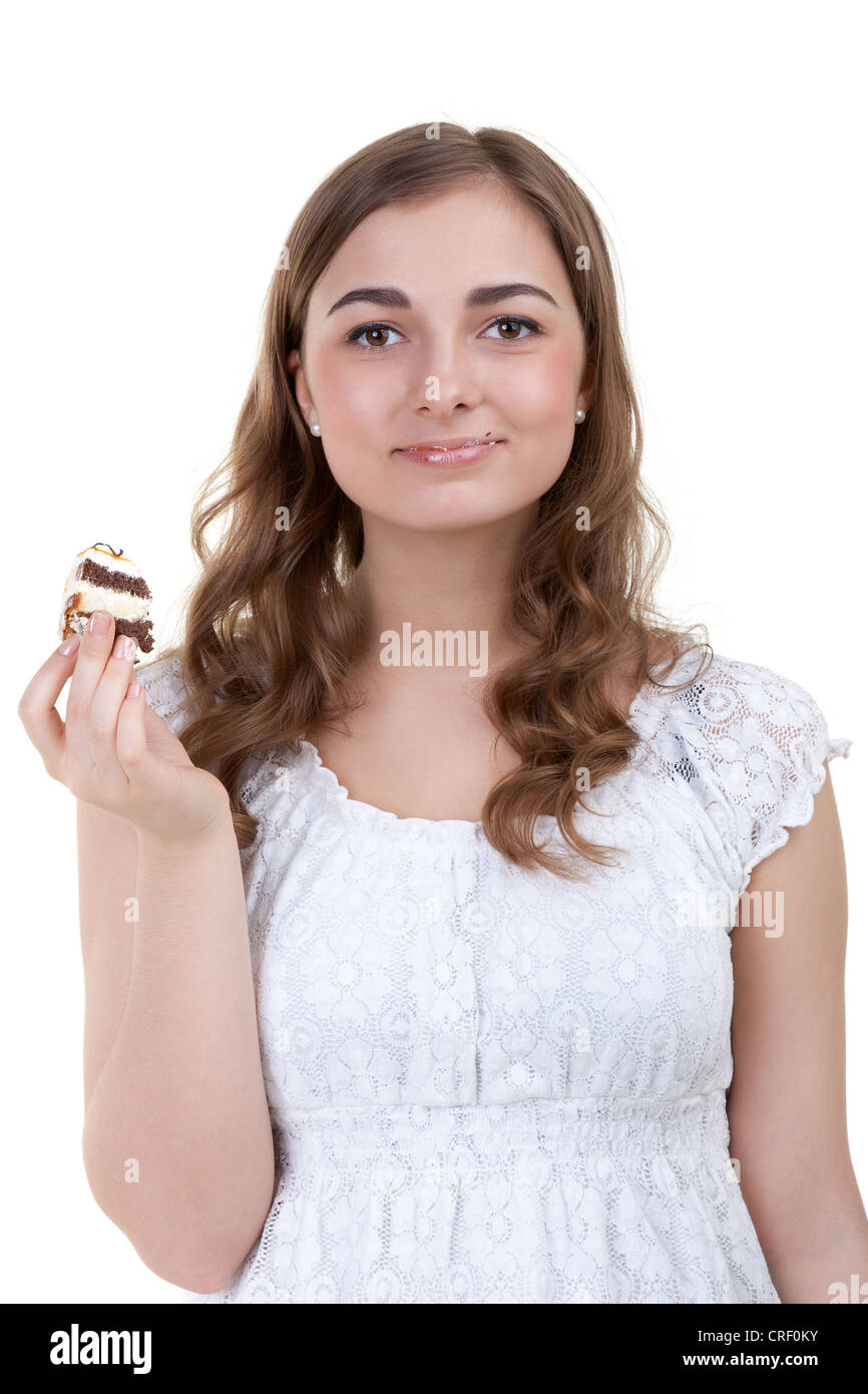Portrait of beautiful smiling girl eating cake crumbs on her lips ...