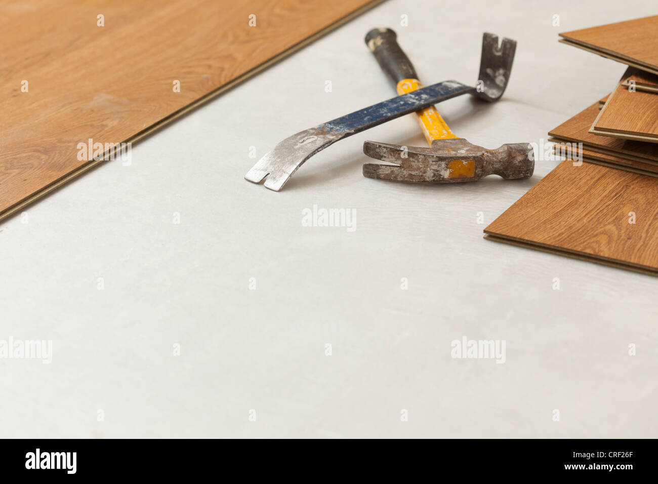 Worn Hammer and Pry Bar with Laminate Flooring Abstract with Copy Room ...