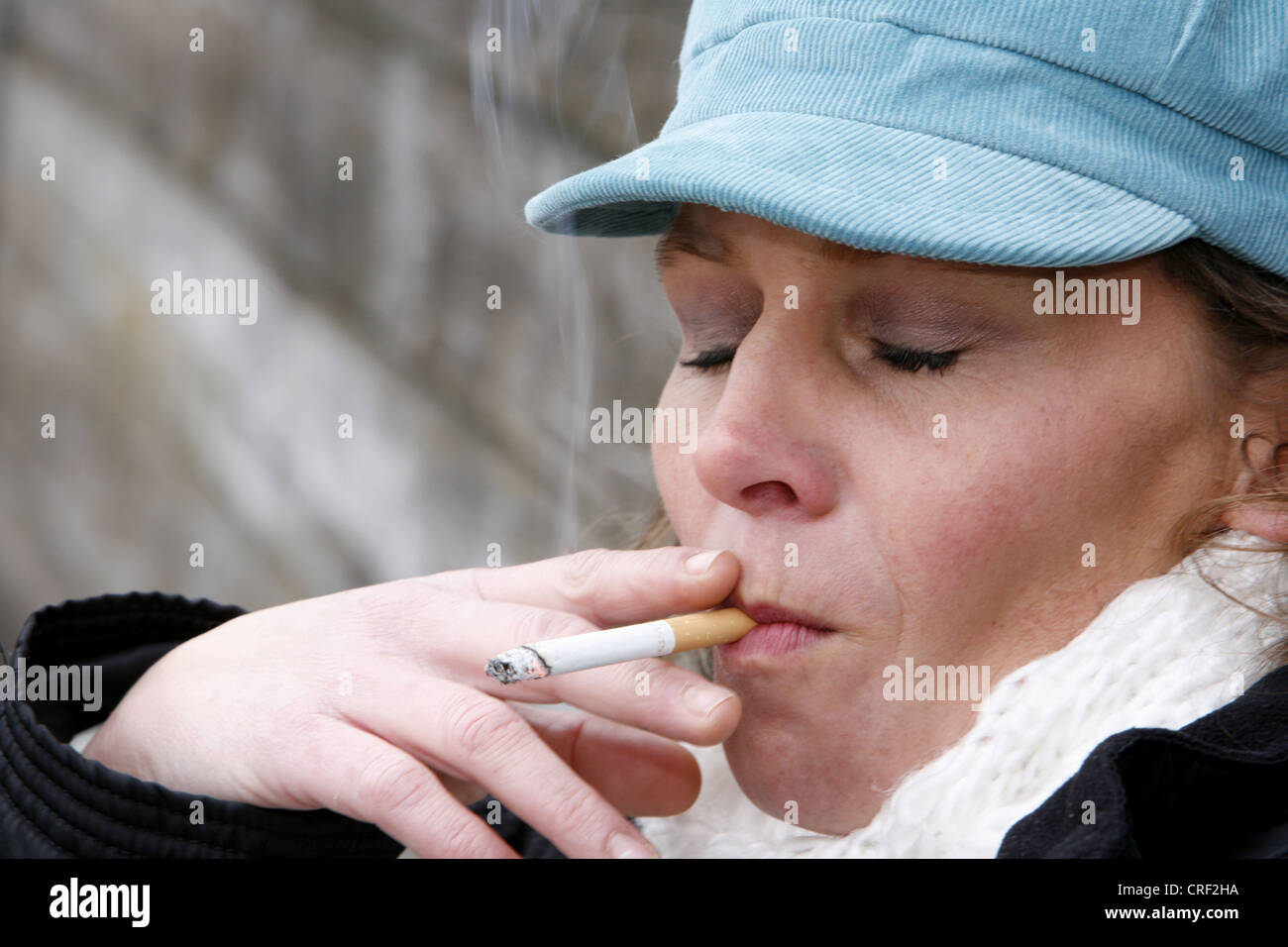 woman around fourty smoking a cigerette Stock Photo - Alamy
