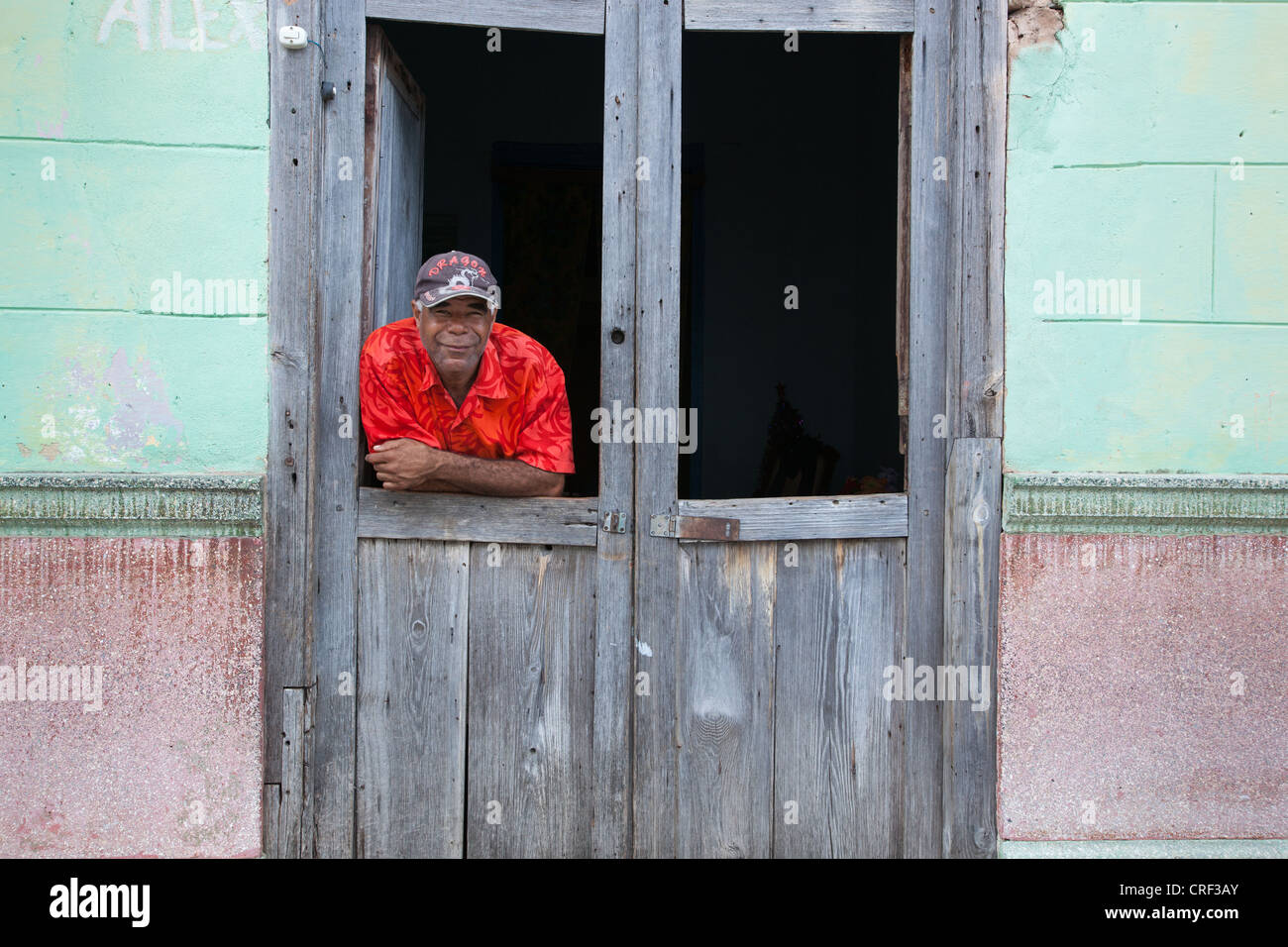 Man standing in open window of door in Trinidad, Cuba Stock Photo - Alamy