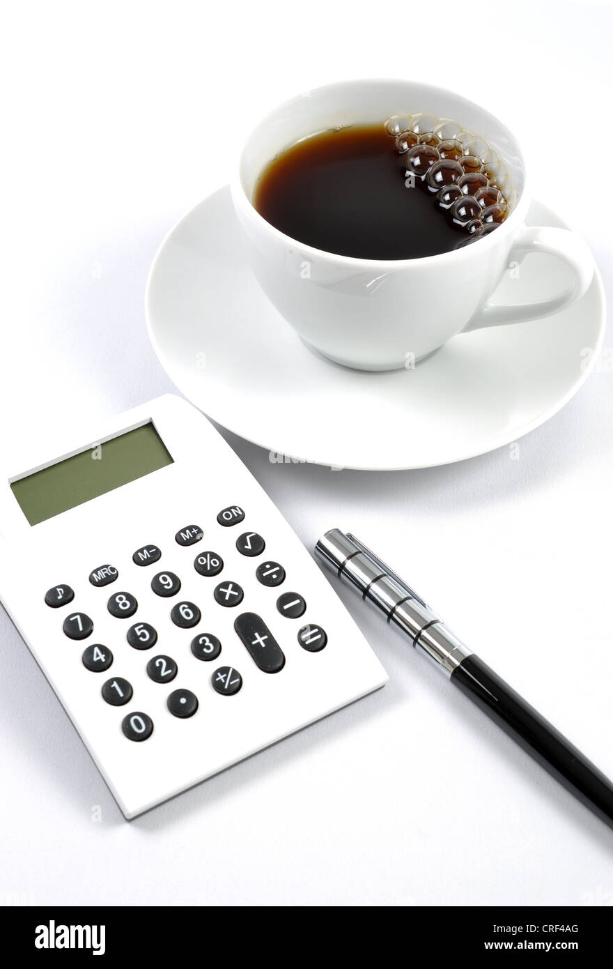 Desk with a calculator and pen Stock Photo - Alamy