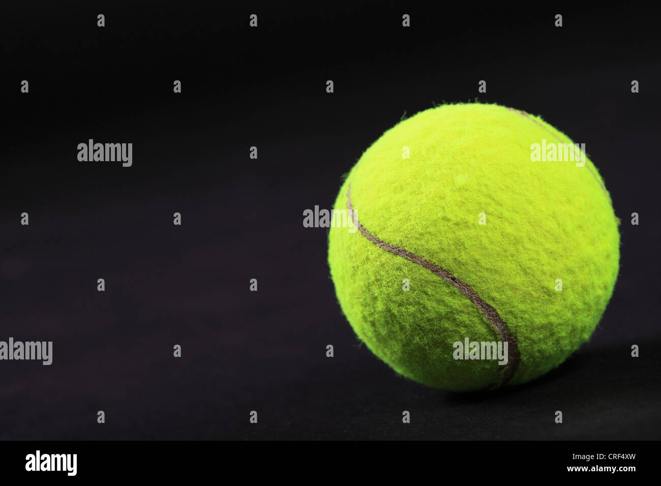 tennis green ball on black background studio shot Stock Photo - Alamy