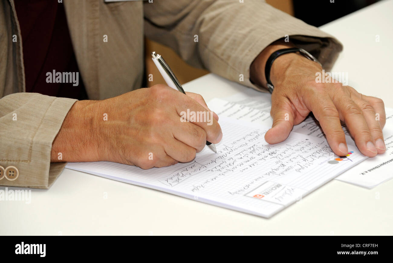 Man Making Notes During Presentation Stock Photo Alamy