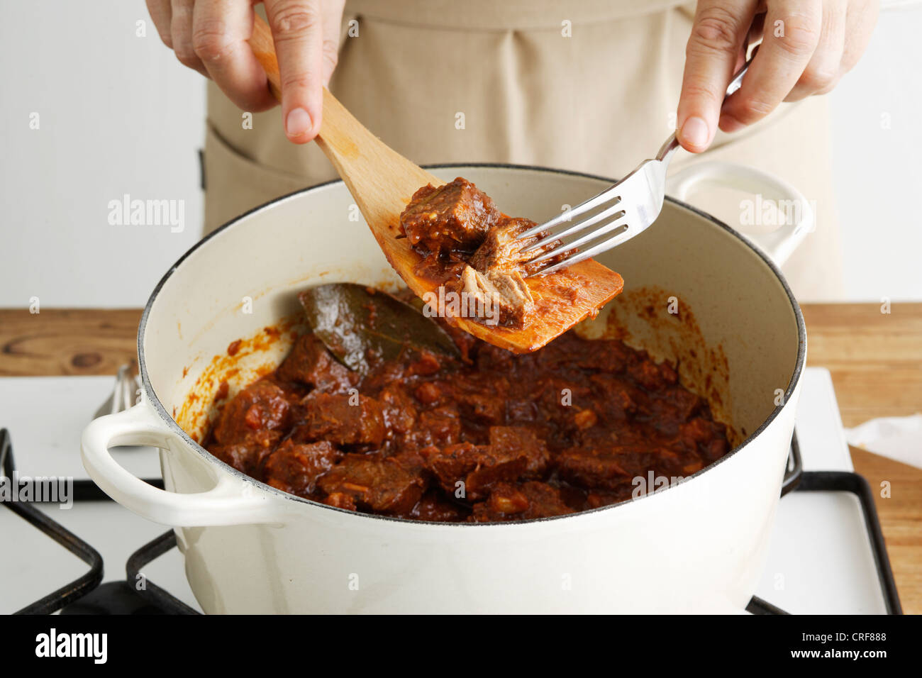 Woman cooking meat stew in hi-res stock photography and images - Alamy