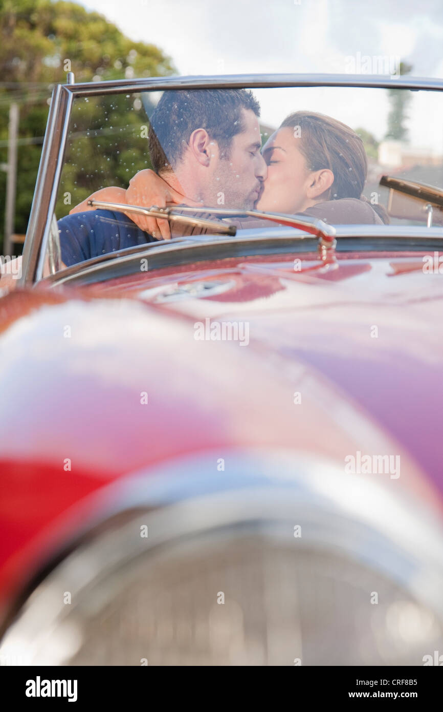 Attractive young couple kissing in car Stock Photo - Alamy