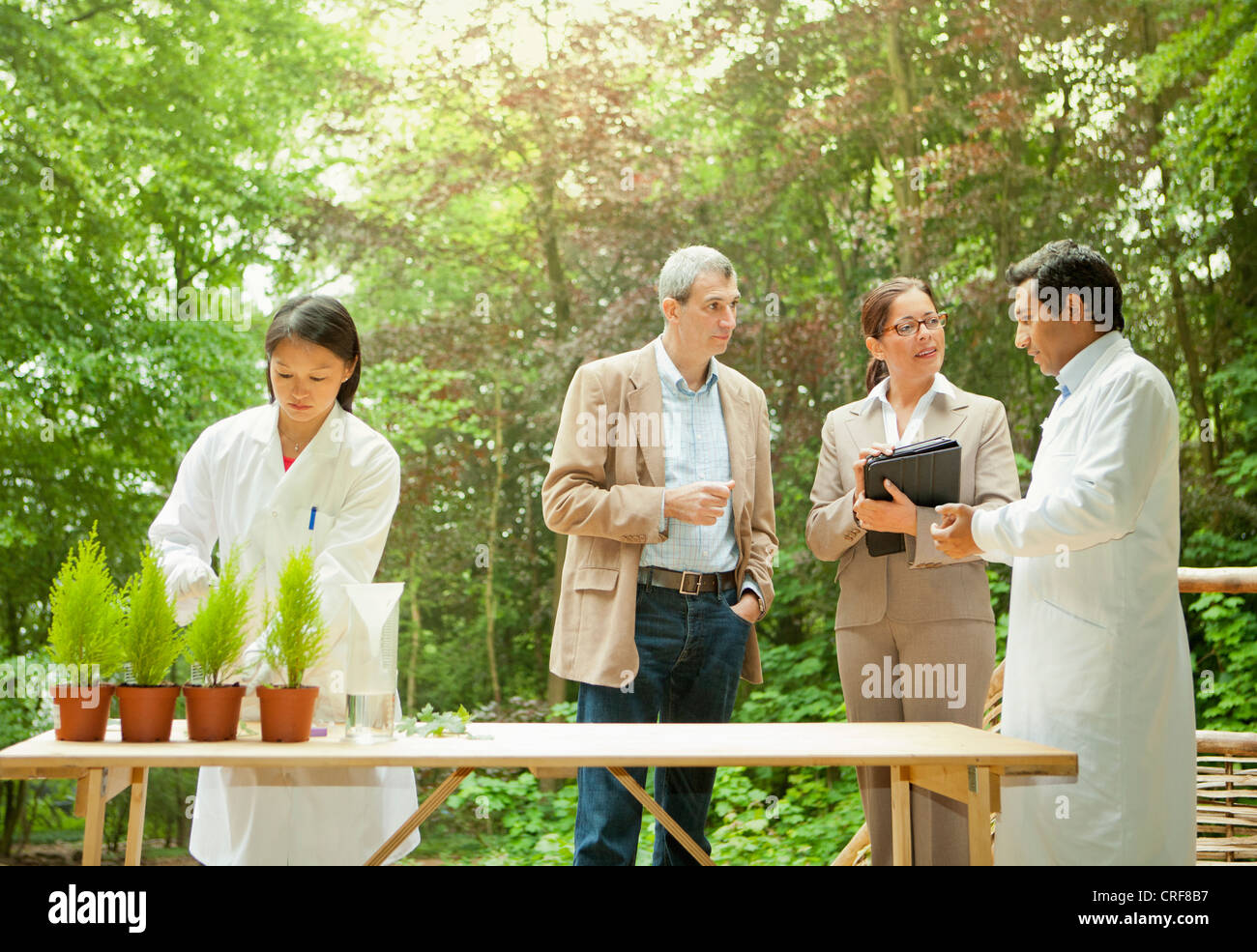 Business people talking with scientists Stock Photo - Alamy