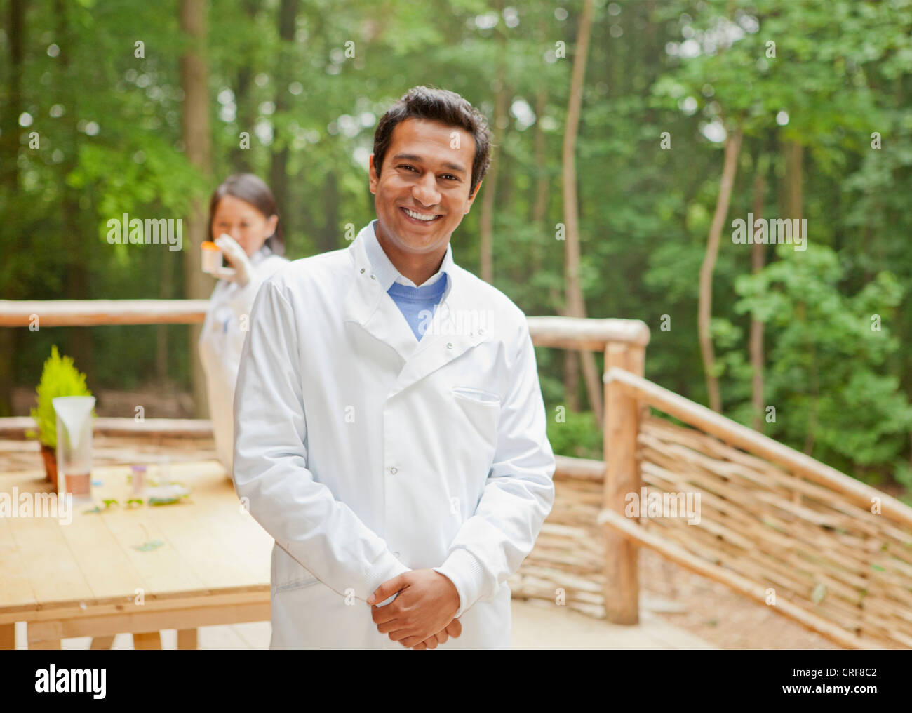 Smiling scientist standing on balcony Stock Photo - Alamy