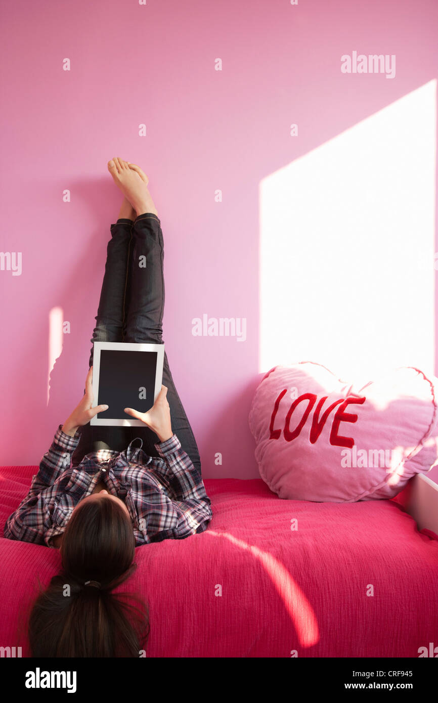 Woman using tablet computer on bed Stock Photo - Alamy
