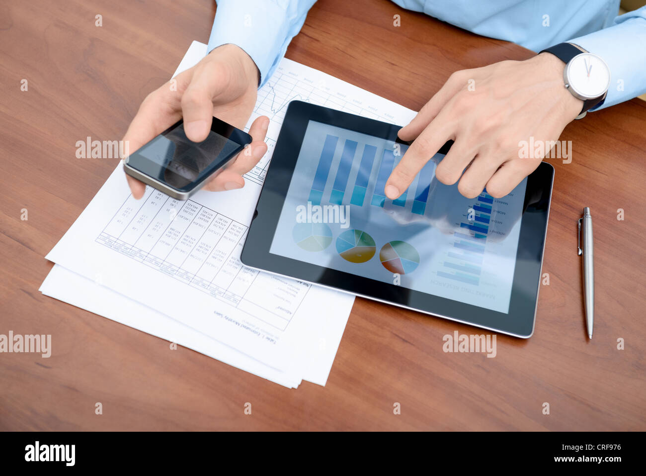 Young businessman working with modern devices Stock Photo - Alamy