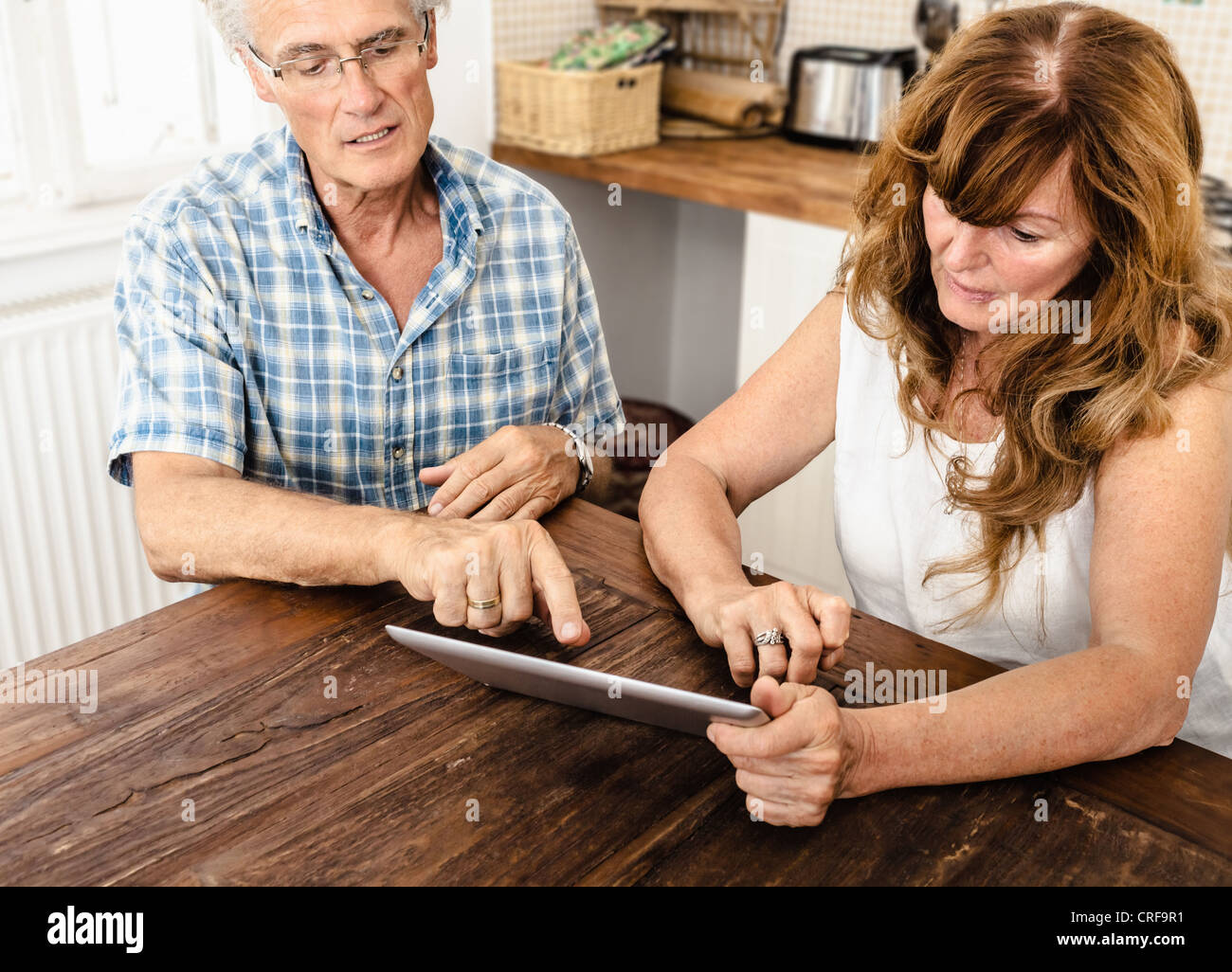 Older couple using tablet computer Stock Photo - Alamy