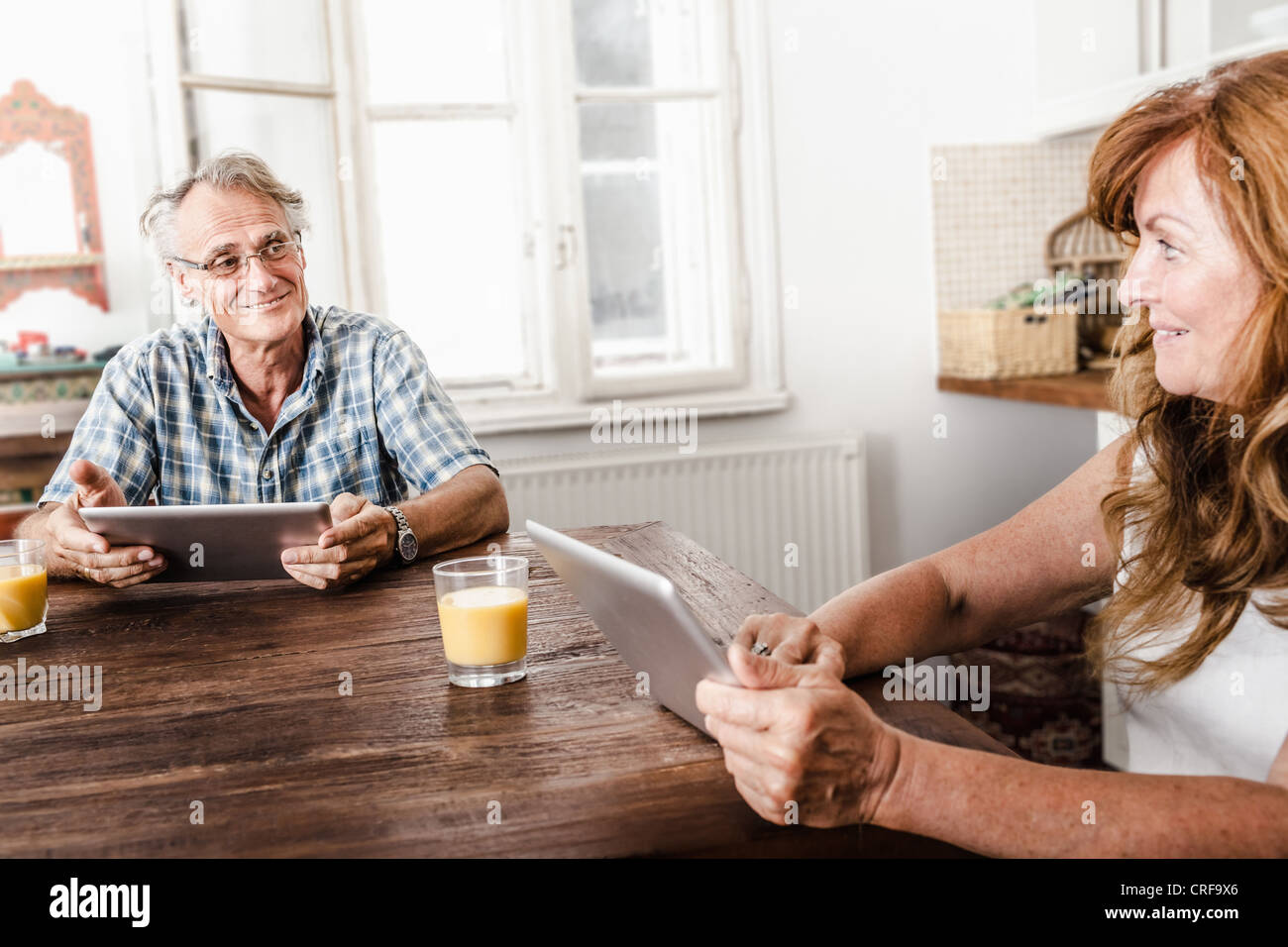 Older couple using tablet computers Stock Photo - Alamy