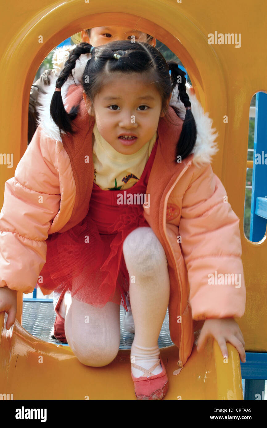 Two children with slides hi-res stock photography and images - Alamy